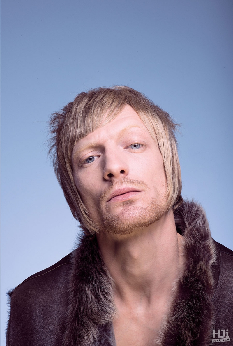 Blonde mid-length hairstyle with a side parting fringe