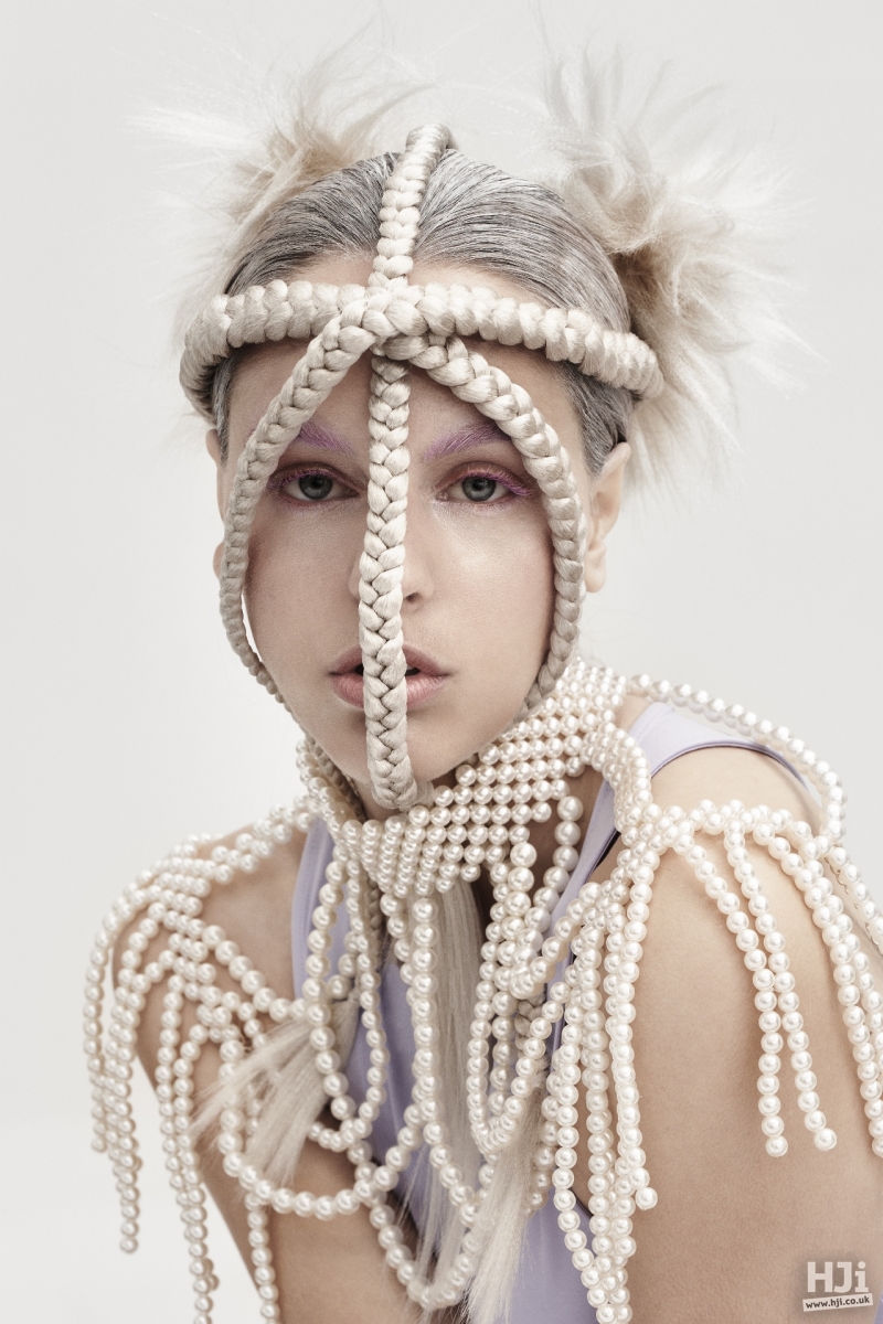 Slick back hair with two top knots and intricate braids placed over the ...